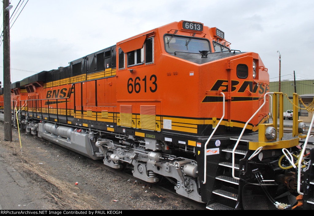 BNSF 6613 is sandwich between her sister C4 Brand New Locomotivers as she sits on the siding ...